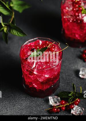 A vertical shot of cocktail with red currant and mint Stock Photo - Alamy