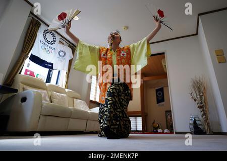 Olympic fan Kyoko Ishikawa shows an image on a TV screen showing her at ...