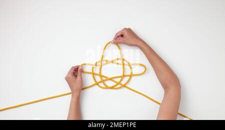 Jury Mast Knot, tying a multiple loop knot, Step 5 Stock Photo - Alamy