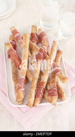 Grissini breadsticks with ham Stock Photo - Alamy
