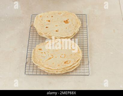 Tortillas on wire cooling tray on kitchen worktop Stock Photo - Alamy