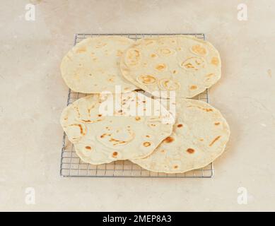 Tortillas on wire cooling tray kitchen worktop Stock Photo - Alamy