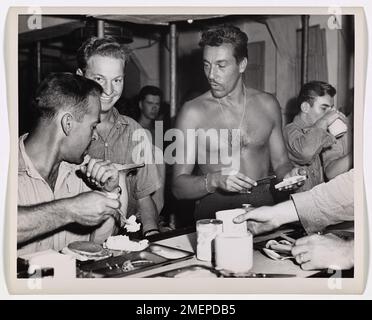 This photograph captures a moment in the mess hall, where military ...