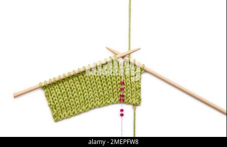 Using beads as stitch and row markers, knitting technique Stock Photo ...