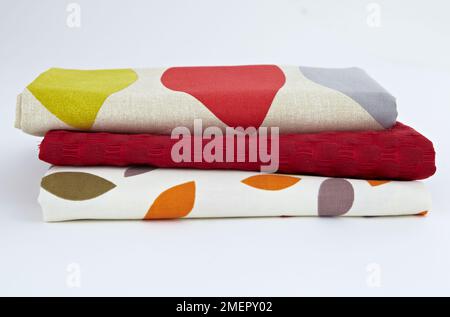 Stack of folded colorful fabrics Stock Photo - Alamy
