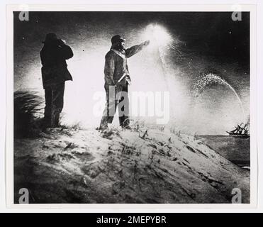 Coast Guardsmen burn Coston signals to mark the wreck site of the A ...