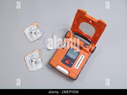 AED automated external defibrillator device on wall chest paddles ...