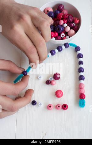 Beads and pipe cleaner Stock Photo - Alamy