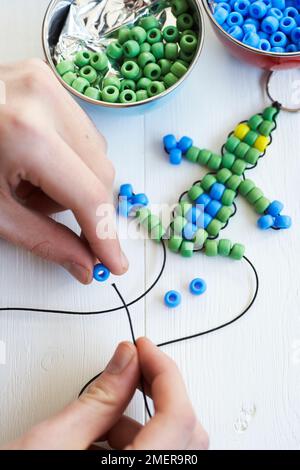 Making beaded lizard key ring Stock Photo - Alamy