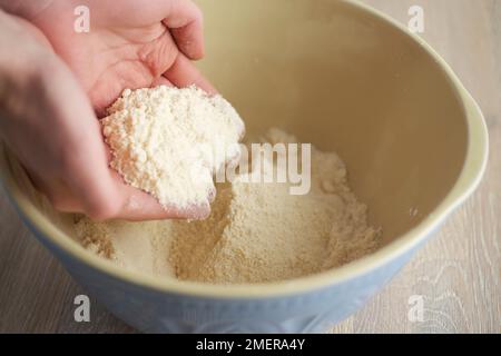 Adding flour to butter and rubbing in, making biscuit dough Stock Photo ...