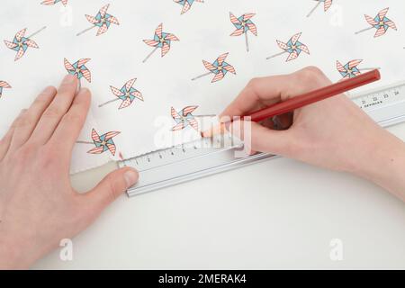 Measure and mark fabric with ruler and tailor's chalk Stock Photo - Alamy