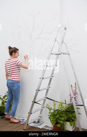 Drawing tree design on outer wall Stock Photo - Alamy