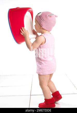 Red hat girl standing in front of Christmas tree lights at night Stock ...