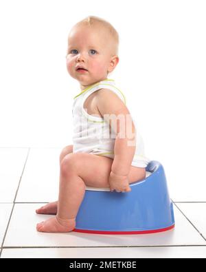 Boy wearing vest sitting on blue potty, 15 months Stock Photo - Alamy