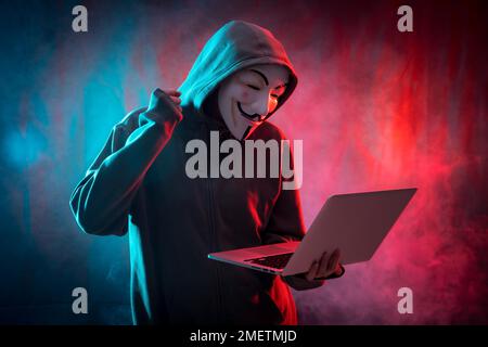 Hacker with anonymous mask with a making fight symbol, with a ...