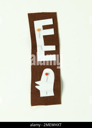 Cutting out heads, horns and feet for attaching to knitted sheep, using ...