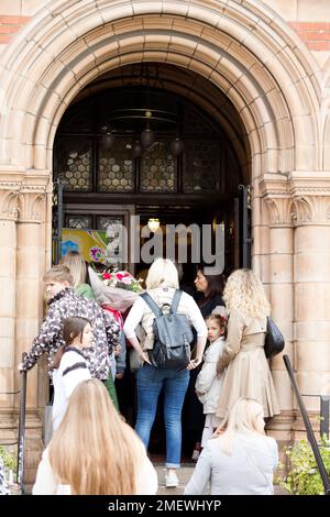 People gather to enter a building in central London Stock Photo - Alamy