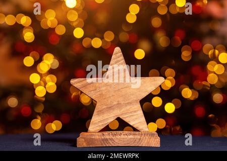 Wooden star for an award. Festive bokeh Stock Photo - Alamy