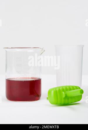 Melted ice lolly liquid in a glass flask Stock Photo - Alamy