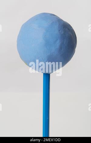 Plasticine model of planet on light blue background, top view. Earth ...