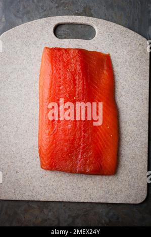Curing fish, step 3: the cured fish on a chopping board with a knife ...