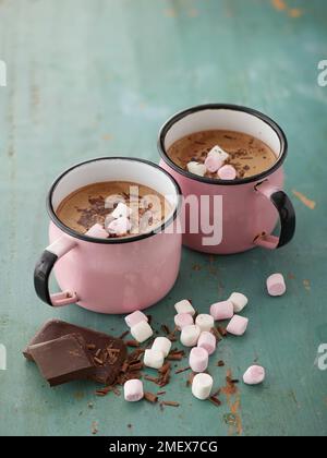A vertical shot of a cup of hot chocolate on the wooden background ...