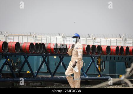 A Ugandan worker from China Oilfield Services Limited (COSL), a ...