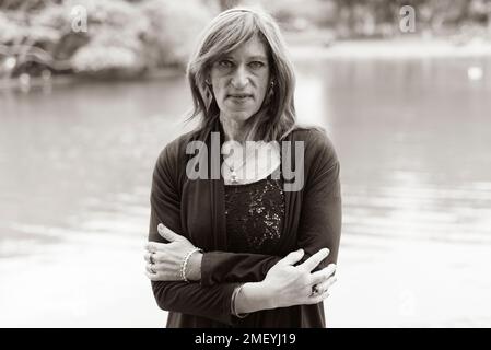 Hispanic transgender man wearing make up and long hair wearing casual ...
