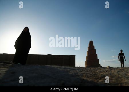 People visit the al-Malwiya minaret at the Al-Mutawakkil Mosque in ...