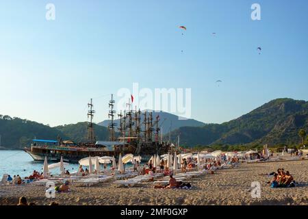 Beachgoers and paragliders in Belcekiz Beach, Oludeniz, Fethiye, Turkey ...