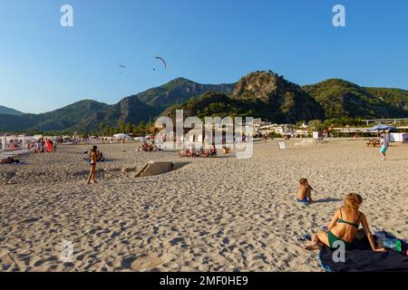 Beachgoers and paragliders in Belcekiz Beach, Oludeniz, Fethiye, Turkey ...
