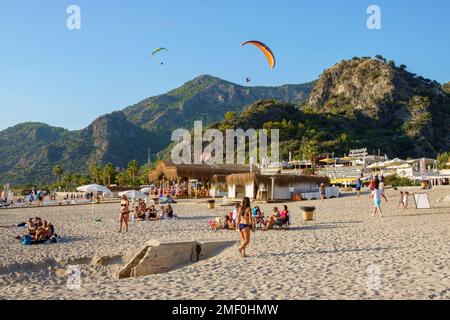 Beachgoers and paragliders in Belcekiz Beach, Oludeniz, Fethiye, Turkey ...