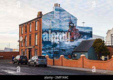 A stunning mural of a lifeboat at sea on the wall of the Ship Inn pub ...