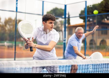 A caucasian padel player jump to the ball, good looking for posts and ...