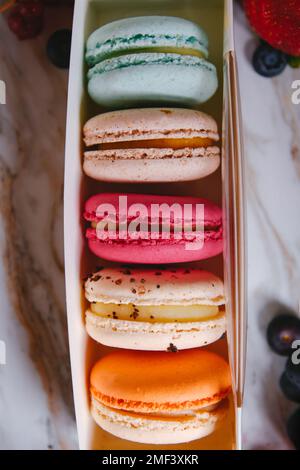 Delicious blueberries and strawberries on pastel colored background ...