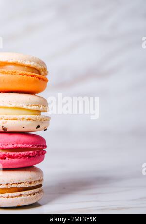 Pink, orange and beige macaroons on marble style. A beautiful and ...