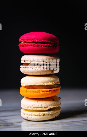 Macaron pink, orange and beige, blue on marble style. French dessert on ...