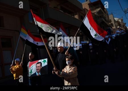 Druse supporters of Syrian President Bashar Assad wave Syrian flags ...