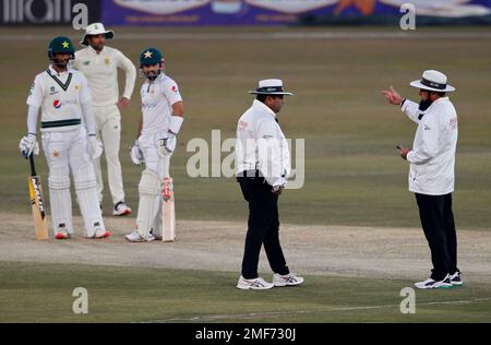 Pakistan's umpire Aleem Dar, right, walks off the field with his ...