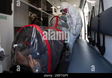 Paramedics in hazmat suits move a COVID-19 patient inside a ...