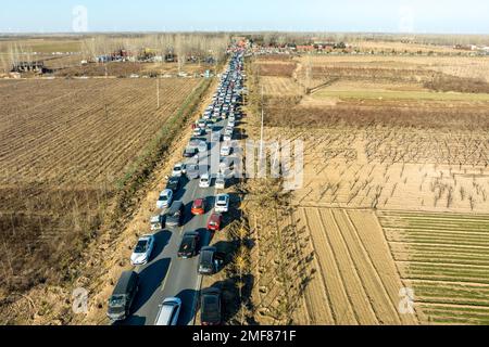 HENAN, CHINA - JANUARY 24, 2023 - Tourist vehicles jam a road for one kilometer near the scenic ...