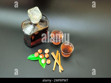 Nut liqueur with cinnamon and mint, strong homemade alcohol on a black ...