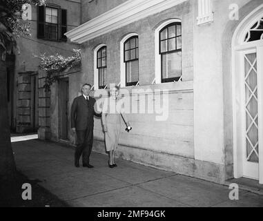 Judge Julius Waties Waring and his wife Elizabeth look at scrap books ...