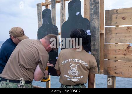 U.S. Navy Chief Gunner's Mate Michael Hoar, right, assigned to the ...
