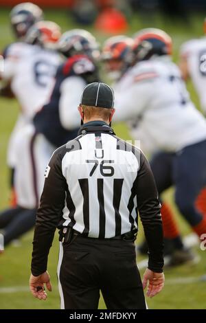 NFL umpire Alan Eck (76) carries the football down the field during an ...