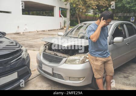 One man reporting car crash damage calling insurance and Claim roadside ...