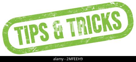 TIPS & TRICKS, text on green-black rectangle stamp sign Stock Photo - Alamy