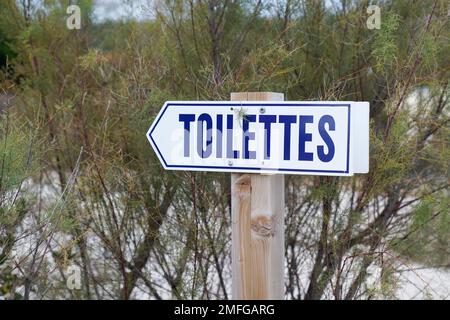 Toilettes french text means wc Toilet sign on wooden arrow water ...