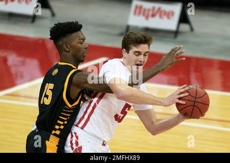 Arkansas-Pine Bluff's Alvin Stredic, center, goes up against Wisconsin ...