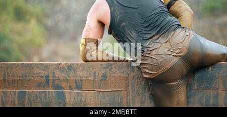 Mud race runners running over obstacles extreme sport Stock Photo - Alamy
